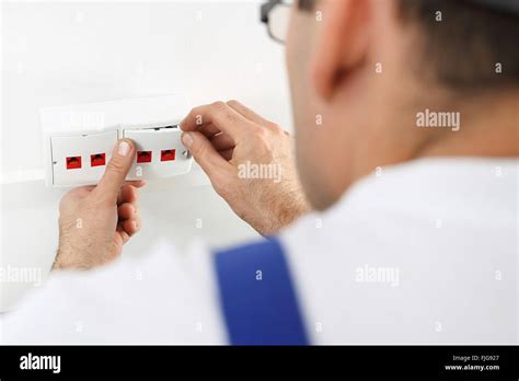 Electrician Installing Internet Installation Of The Wall Socket Man Mounts In A Wall
