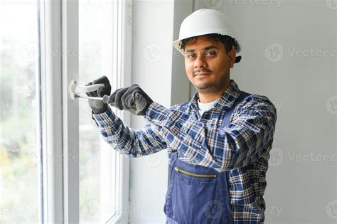 Indian Service Man Installing Window With Screwdriver Stock Photo At Vecteezy