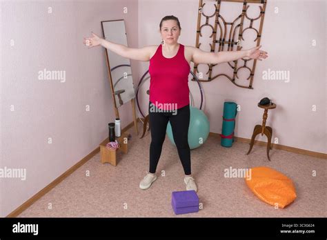 Middle Aged Woman Stands With Arms Outstretched Five Pointed Star Pose