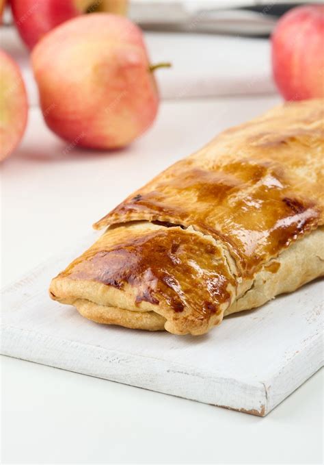 Premium Photo Baked Strudel With Apples On A White Wooden Board Delicious Dessert
