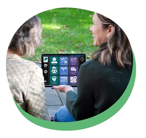 Hannah From Smartbox Holding An Ipad With Grid Displayed Smiling At