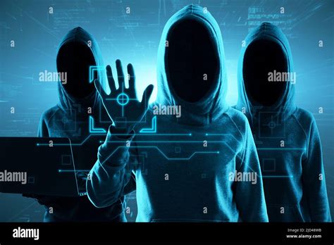 Hacking Attack And Internet Security Concept With Faceless Hackers In Hoody Using Laptop And