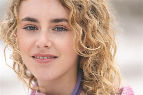 Premium Photo Woman Standing On Beach While Looking At Camera