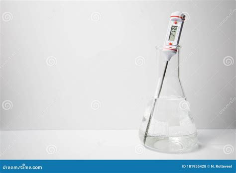 A Digital Thermometer Measuring The Temperature Of A Liquid In A Glass
