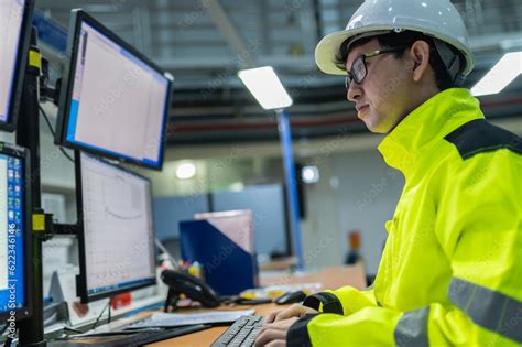 Inside The Large Industry Factory Female Computer Engineer Works On Personal Computer She Coding