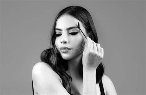 Combs Eyebrows With A Brush In A Beauty Salon Woman With Long Eyelashes And Thick Eyebrows