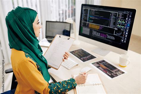 Serious Pensive Young Muslim Software Developer Looking On Programming Code On Computer Screen