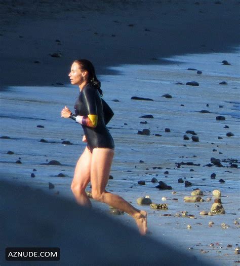 Minnie Driver Swimming Way Out In The Middle Of The Ocean Wearing A Cut Off Leg Wetsuit In