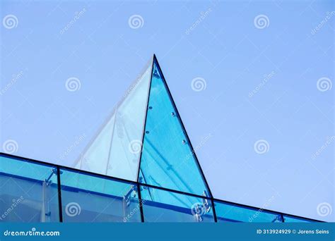 The Triangular Glazed Facade Of The Building Is Oriented With A View