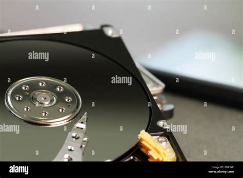 Close Up Of Open Computer Hard Disk Drive On Desk And Notebook Stock Photo Alamy