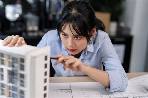 Premium Photo Asian Architect Engineer Women Looking On Building Model And Examining Mistake