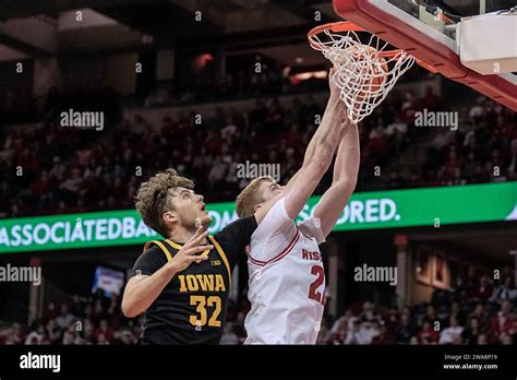 Wisconsins Steven Crowl 22 Grabs A Defensive Rebound Against Iowas Owen Freeman 32 During