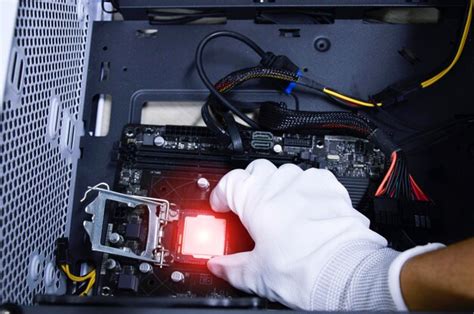 Premium Photo Technician Is Inserting A Cpu Chip On A Computer Motherboard