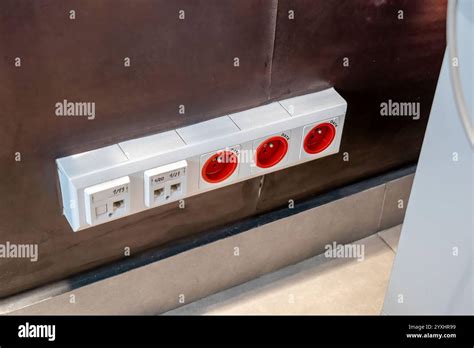 Rj45 Ethernet Internet Ports And Red Data Power Sockets In A Row On An Office Wall Interior
