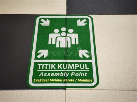 A Green Emergency Sign On The Station Floor Indicating An Assembly
