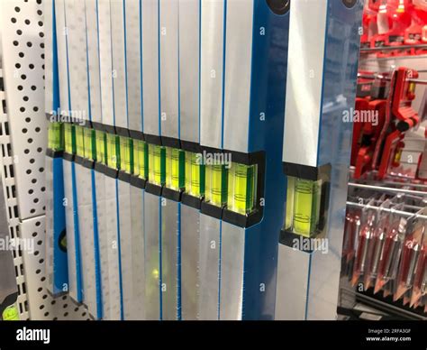 Tool Level In Mens Hands And A Flat Horizontal Surface Of The Ceiling