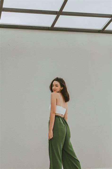 A Woman In A White Top And Green Pants Photo Free Portrait Image On