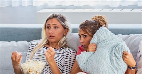 집 거실의 소파에 앉아 밤에 Tv를 보는 겁에 질린 친구들 여자 친구와 무서운 영화의 밤 집에서 무서운 영화를 보는 겁에 질린 젊은 여성 사진 Unsplash의 서