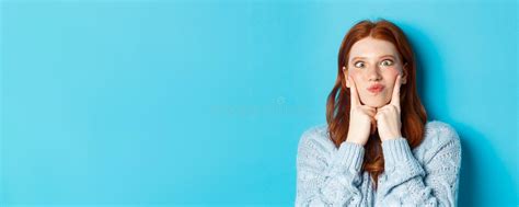 Close Up Of Funny Redhead Teen Girl Making Faces Squinting And Pocking