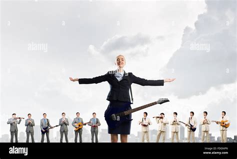 Man Orchestra Playing Different Music Instruments And Woman Leader Stock Photo Alamy