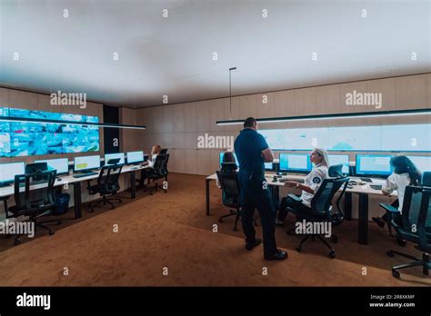 Group Of Security Operators Working In A Data System Control Room Technical Operators Working At