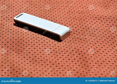 A Modern Portable USB Wi Fi Adapter Is Placed On The Red Sportswear Made Of Polyester Nylon Fibe