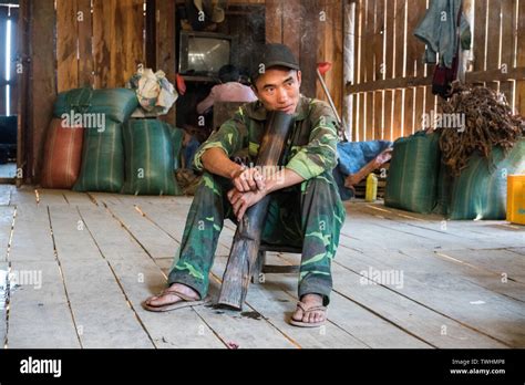 Man Smoking Opium By Traditional Tobacco Pipe In The Akha Pixor Village
