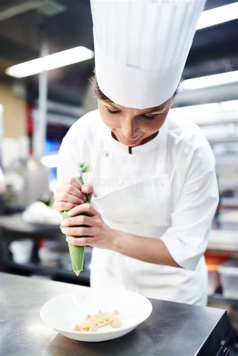 Making Dessert Look As Good As It Tastes A Chef Preparing Dessert In A Professional Kitchen