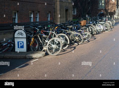 Large Row Of Cycles Parked In Cambridge With Cycle Parking Sign Stock