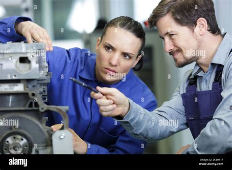 Awo Mechanics Man And Woman Examining Car Engine Stock Photo Alamy