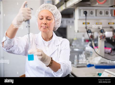 Efficient Female Lab Technician Working With Reagents In Test Tubes During Chemical Experiment