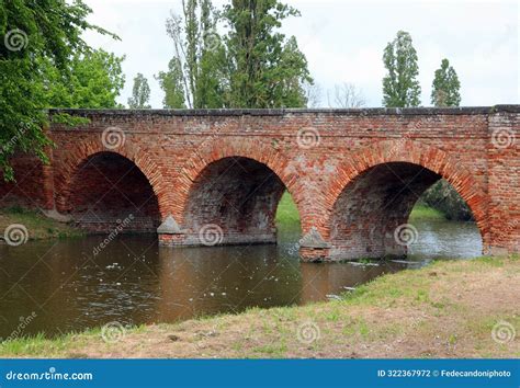 Medieval Bridge Made Of Red Bricks With Three Perfect Arches Over A