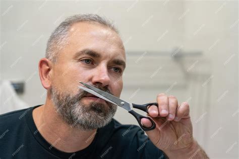 Premium Photo Close Up Of Man Holding Thermometer