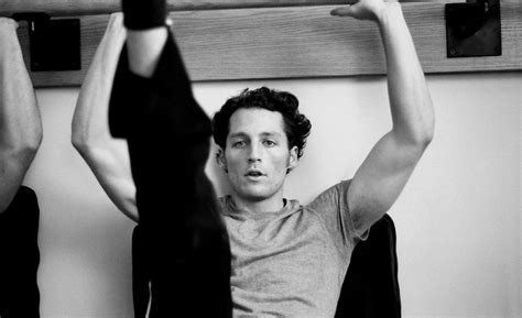 Black And White Photograph Of Two Men Doing Exercises With Their Hands In The Air