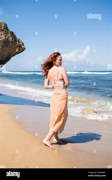 Solo Woman In A Bikini With Towel At The Beach In Puerto Rico Stock