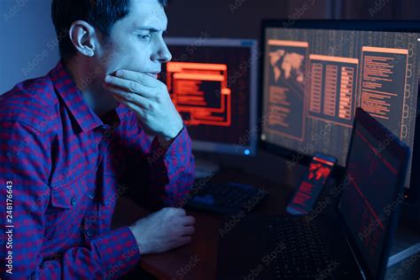 Hacker Thinking About The Problem Of Hacking On The Background Of Screens With Codes In Neon