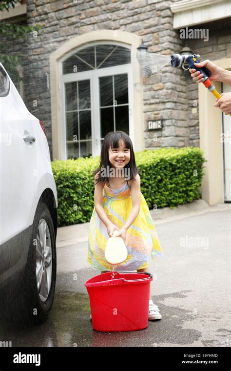Girl Helping Father Cleaning Car Stock Photo Alamy