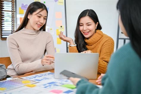 Premium Photo A Team Of Asian Application Interface Designers Are In The Meeting Business
