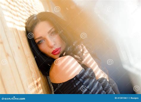 Beautiful Brunette Young Woman With Red Lips Looking At Camera
