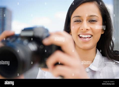 Mixed Race Woman Taking Photographs Stock Photo Alamy