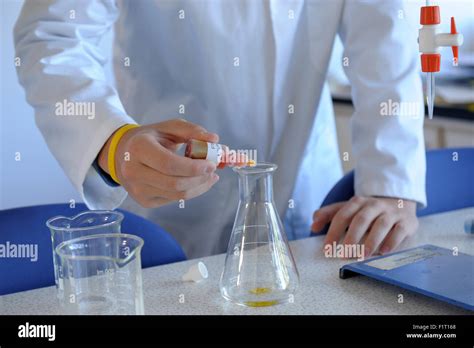 Science Babe Adding Chemical To A Mixing Flask Stock Photo Alamy