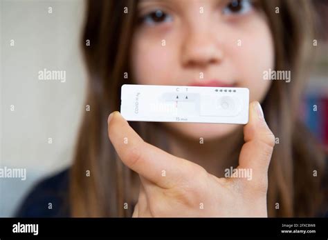 Girl Holding Rapid Diagnostic Test At Home Showing Negative Result Stock Photo Alamy