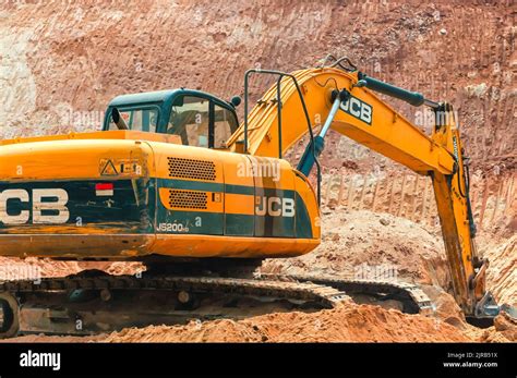 A JCB Bulldozer Backhoe Loader Dozer Crawler Excavating Huge Volumes Of Sand While