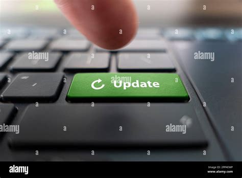Man Pressing Green Button With Word Update On Modern Black Computer Keyboard Closeup Stock