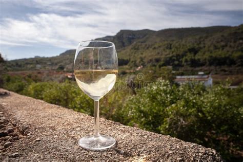 Stemmed Glass Of Chilled Spanish White Wine Rests On A Stone Ledge