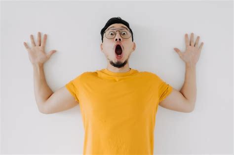 Premium Photo Shocked Surprised Face Asian Man Yellow Tshirt