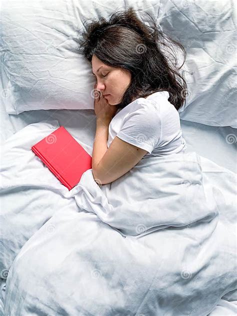 Young Millennial Candid Woman Is Sleeping At Home On A White Stripped