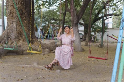 Premium Photo Woman Swinging In An Outdoor Park