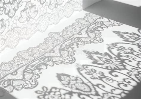 Delicate Lace Fabric Casting Intricate Shadows On A White Surface Stock