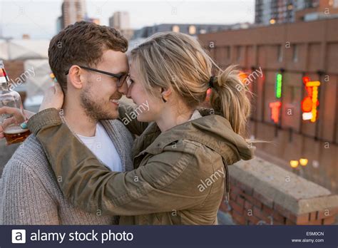 Couple Hugging Face To Face On Urban Rooftop Stock Photo Alamy